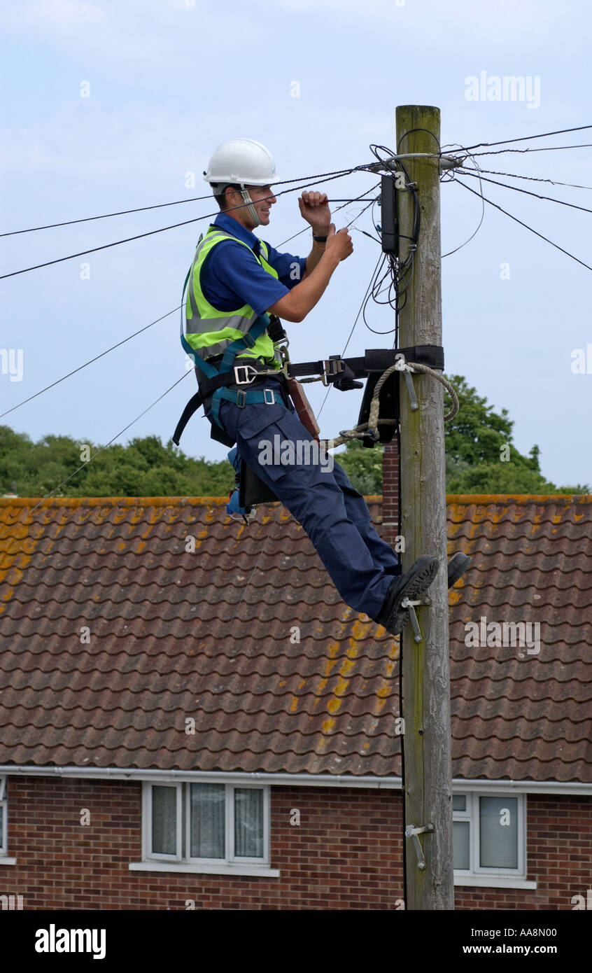 A Telephone Engineer at work wearing full and correct safety equipment ...