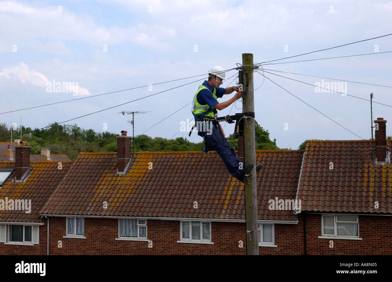 A Telephone Engineer at work wearing full and correct safety equipment ...