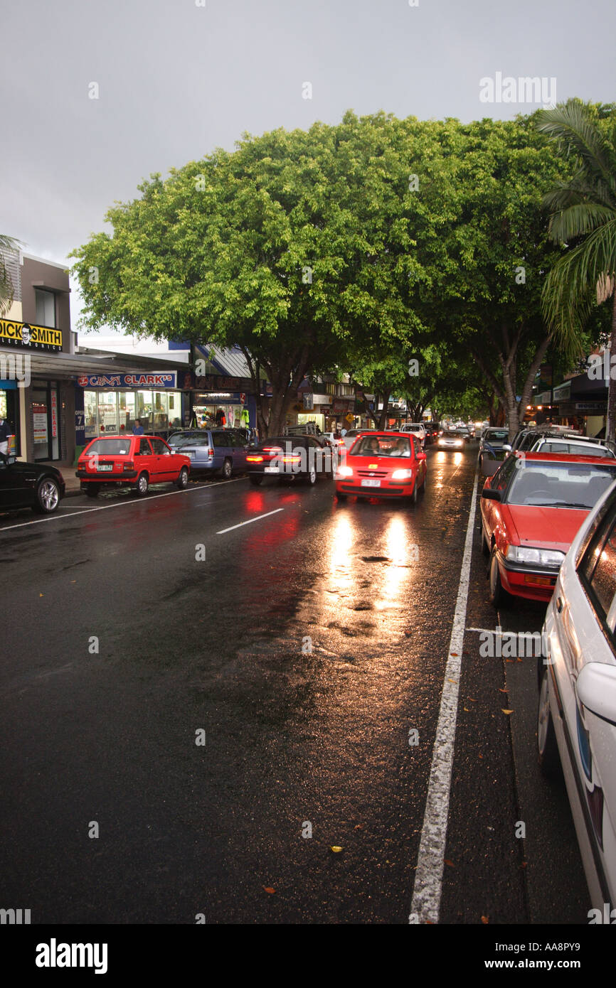 CARS DRIVING ALONG A SUBURBAN STREET QUEENSLAND AUSTRALIA VERTICAL ...