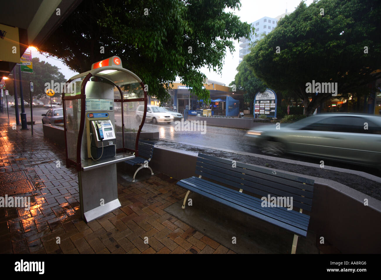CARS DRIVING ALONG A SUBURBAN STREET QUEENSLAND AUSTRALIA HORIZONTAL ...