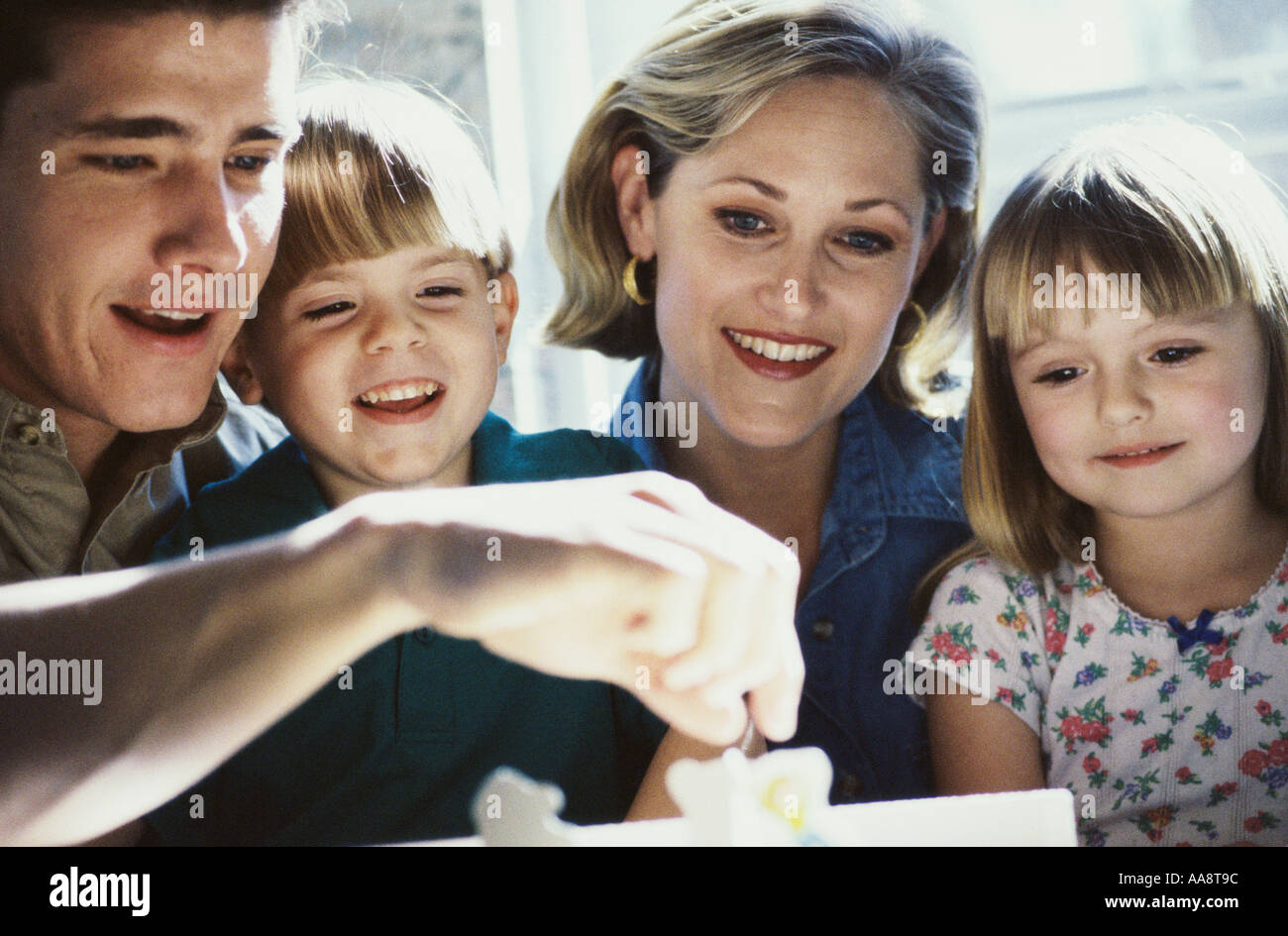 Parents and their two children smiling Stock Photo - Alamy