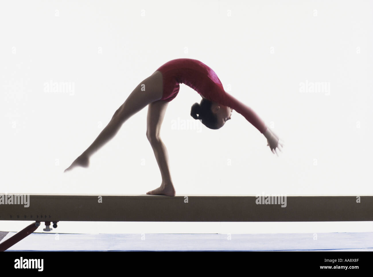 Teenage girl on a balance beam Stock Photo - Alamy