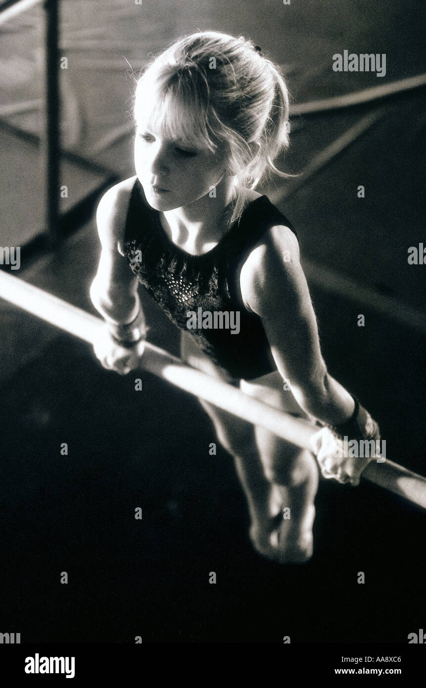 Girl performing gymnastics on uneven parallel bars Stock Photo - Alamy