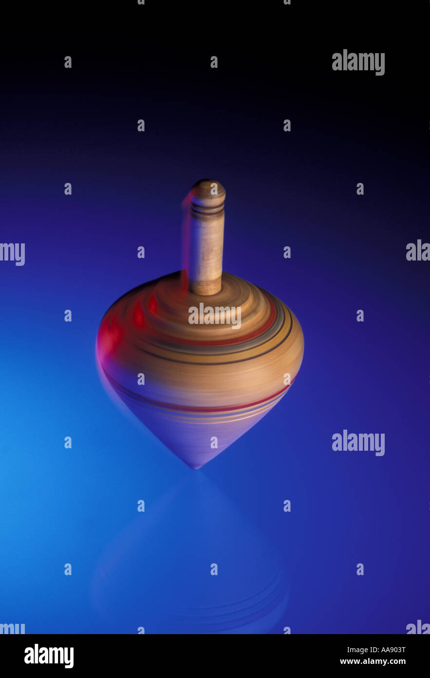 A spinning top on blue lit Plexiglas Stock Photo - Alamy