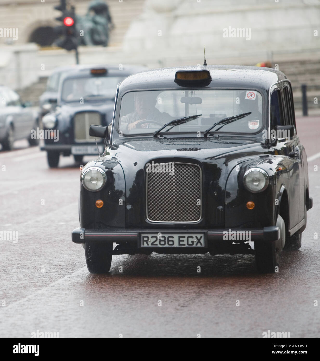 Taxi cabs in front of the Queen Victoria memorial the Mall London ...