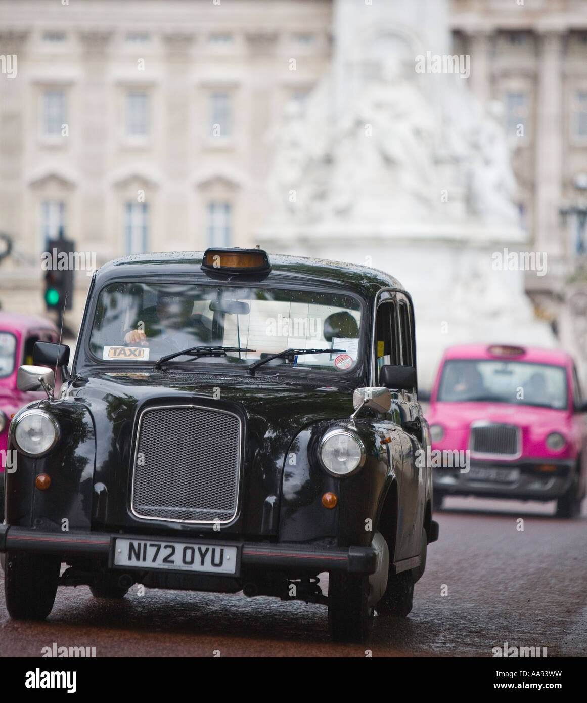 Taxi cabs in front of the Queen Victoria memorial the Mall London ...