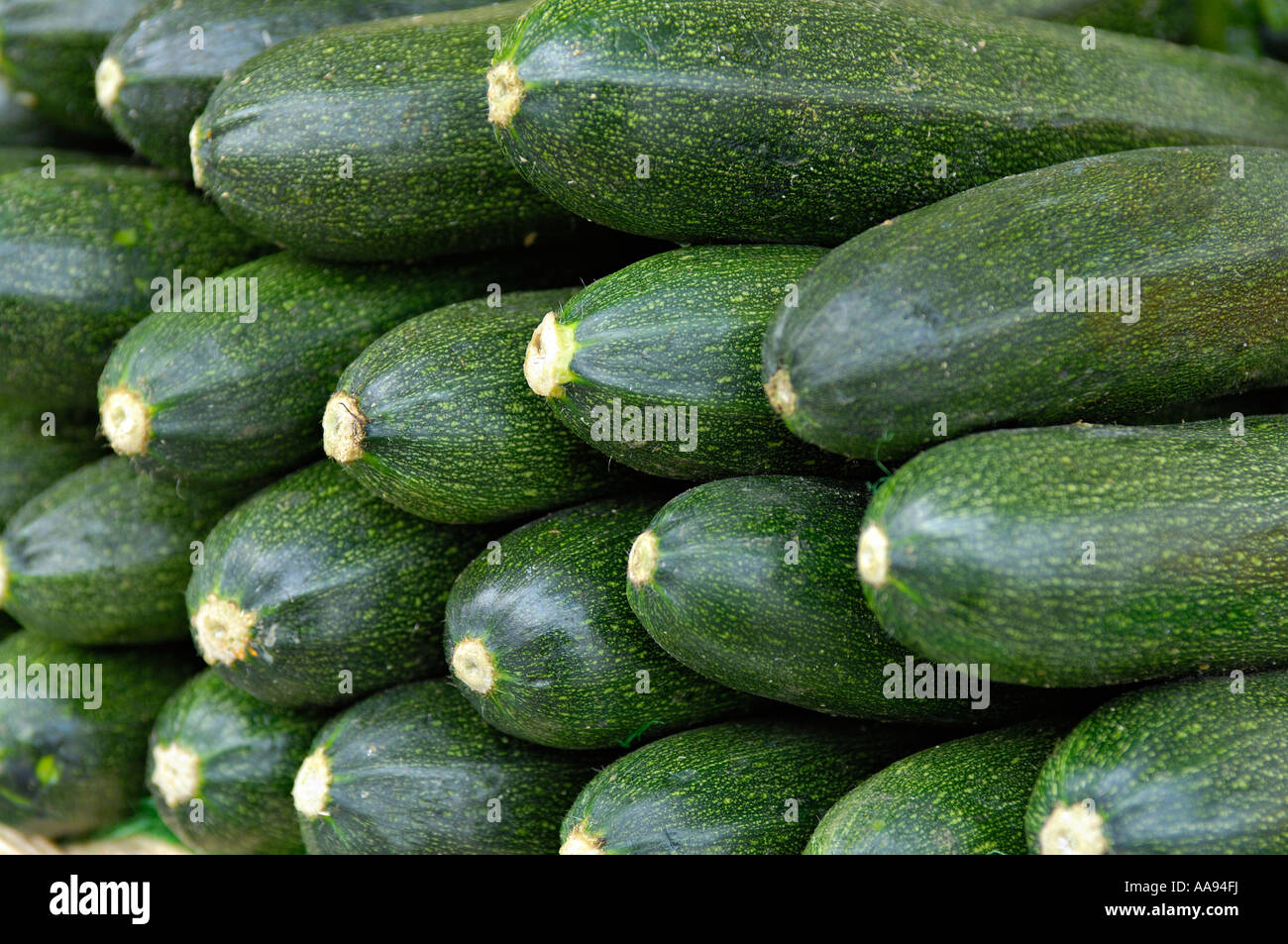Stacking courgettes on a market stall. France Stock Photo - Alamy