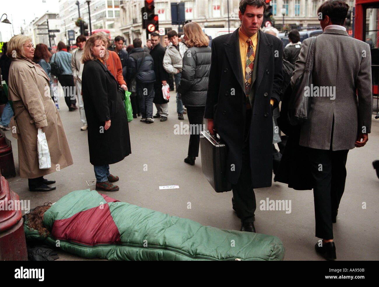 Homeless person in sleeping bag lying across Oxford Street in London as ...