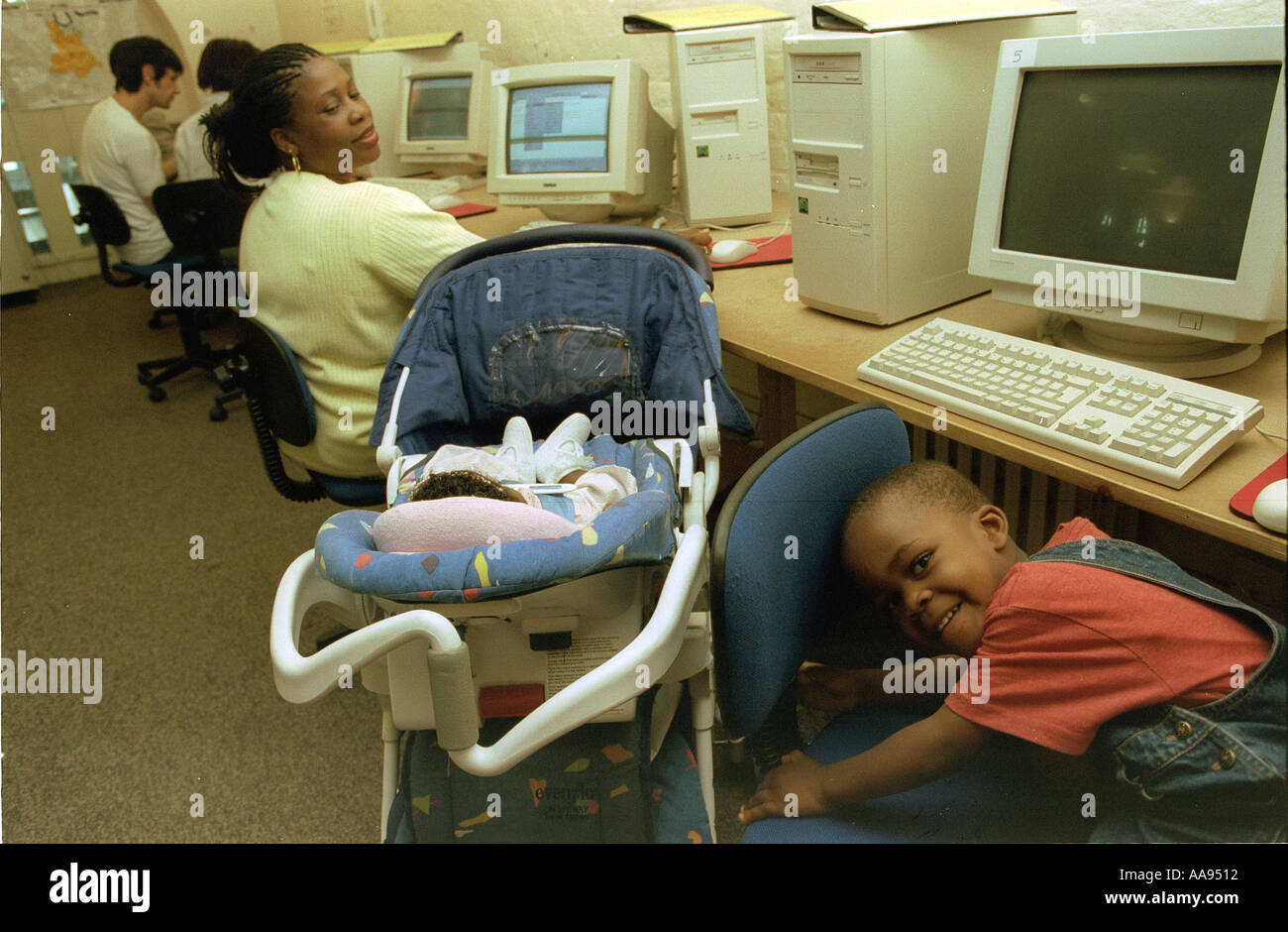 Parents working on and learning computer skills whilst their children ...