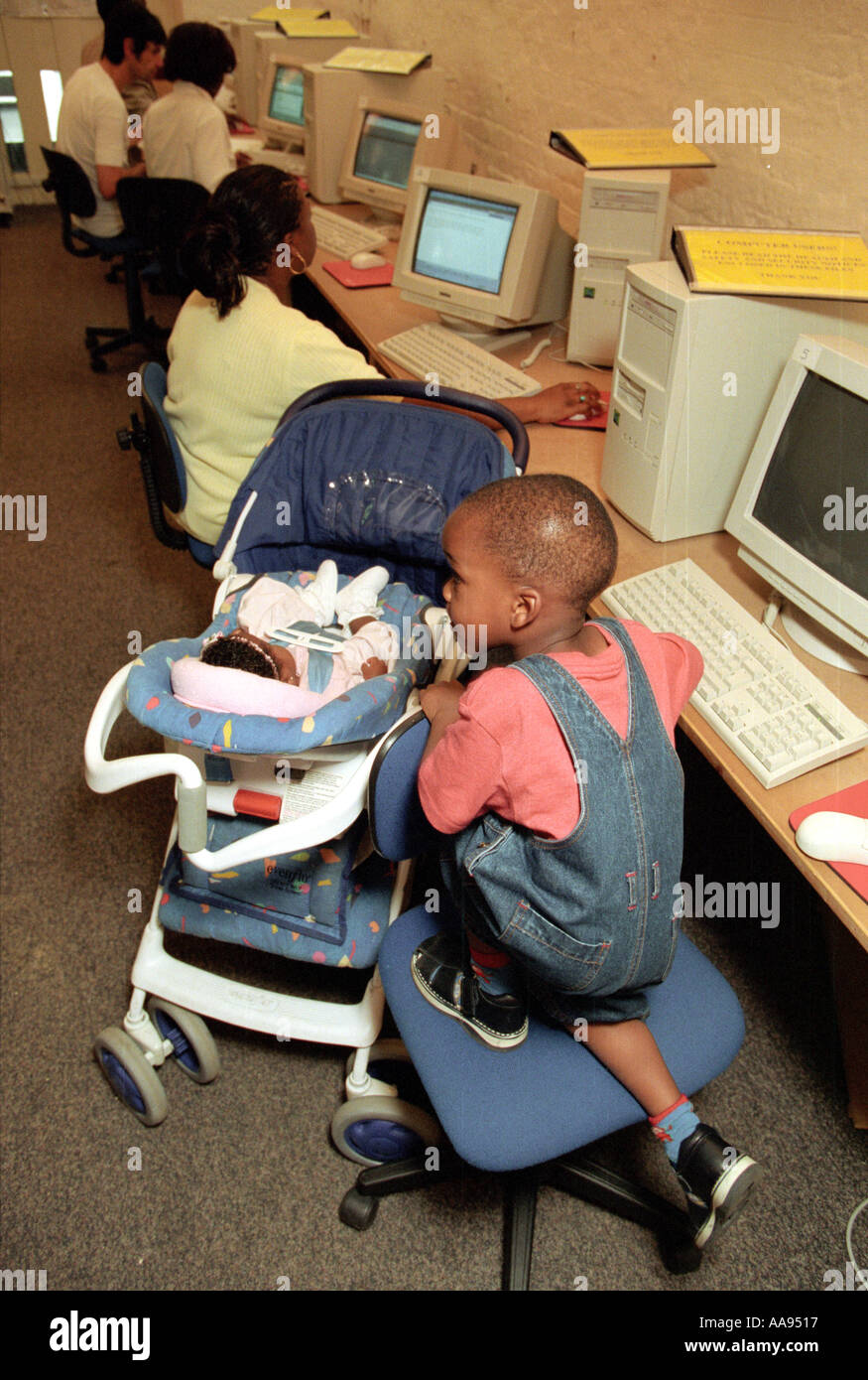 Parents working on and learning computer skills whilst their children ...