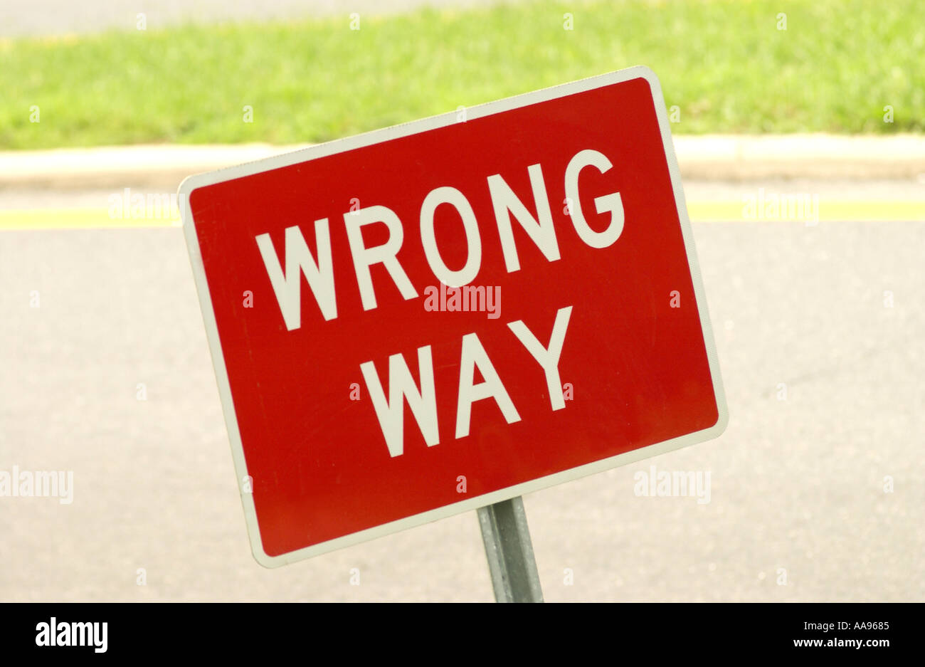 Horizontal color image of a wrong way sign along a public road or ...