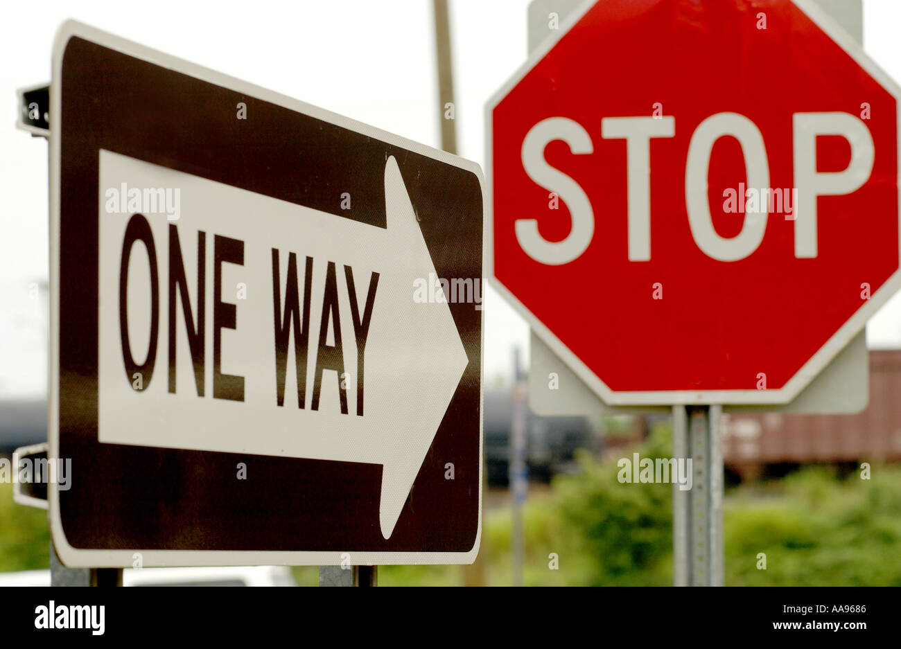 Vertical color image of a one way street sign and a stop sign at an ...