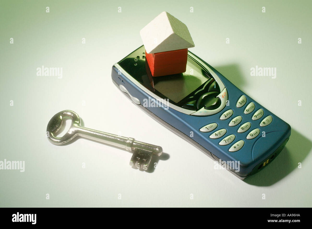 Mobile Phone with Key and Miniature House Stock Photo - Alamy