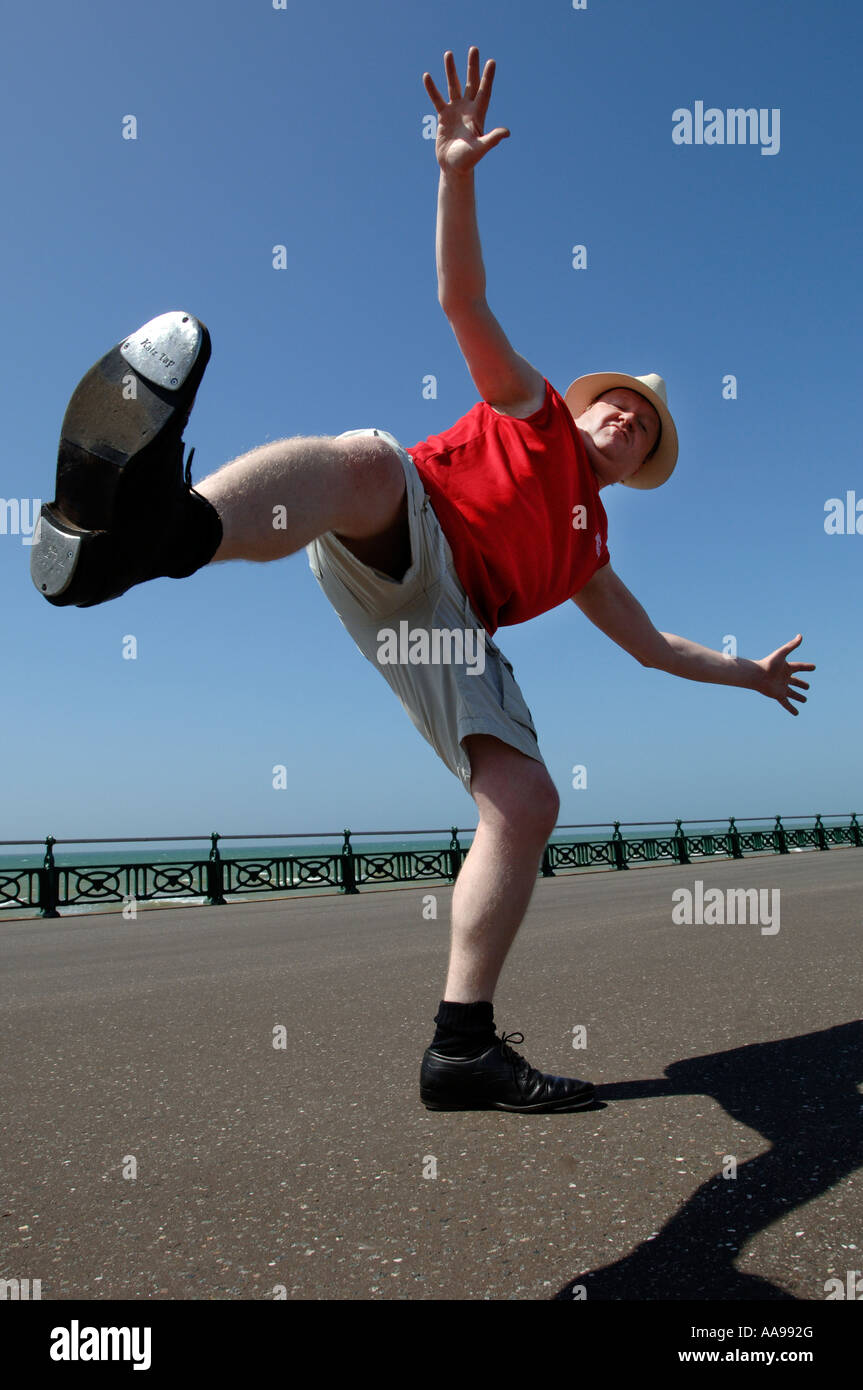 One serious looking middle aged man doing clumsy high kicking dance ...