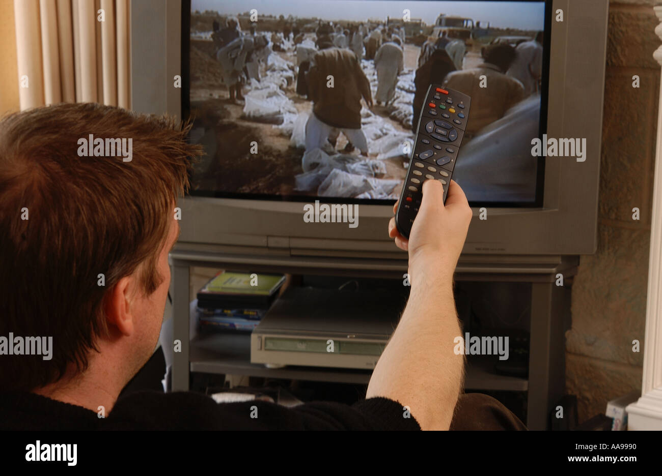 man changing television chanels when watching tv Stock Photo - Alamy