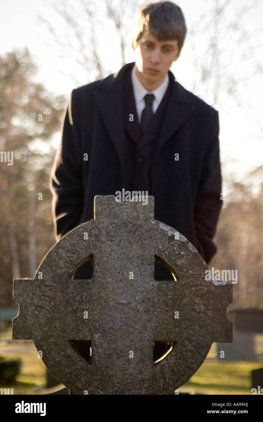 man mourning infront of gravestone on funeral Stock Photo - Alamy
