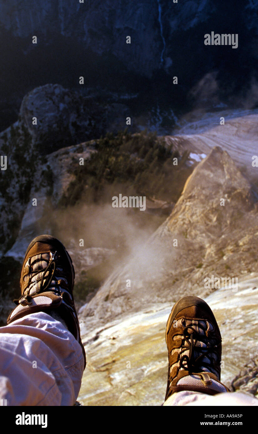 The view looking downwards at the steep drop between climbing boots ...