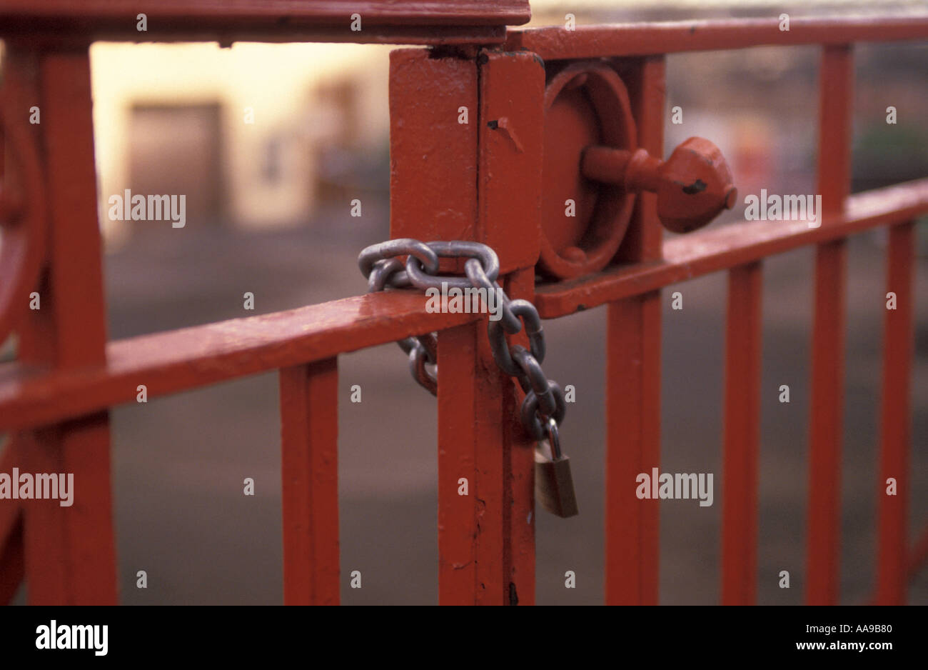Chain and Padlock Around a Red Gate Stock Photo - Alamy
