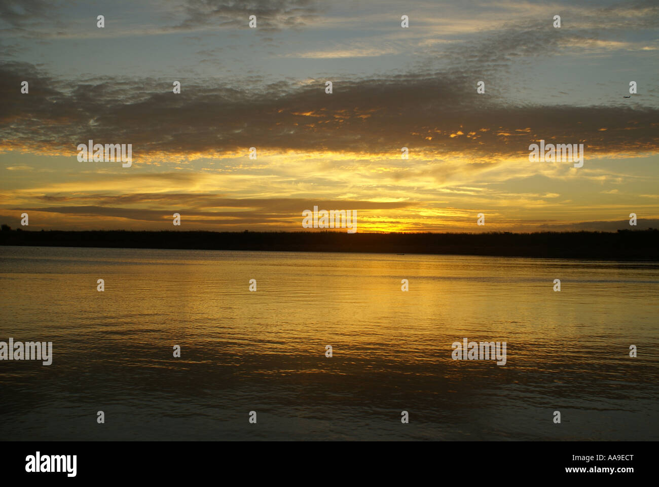 Golden sunset over dam Stock Photo - Alamy