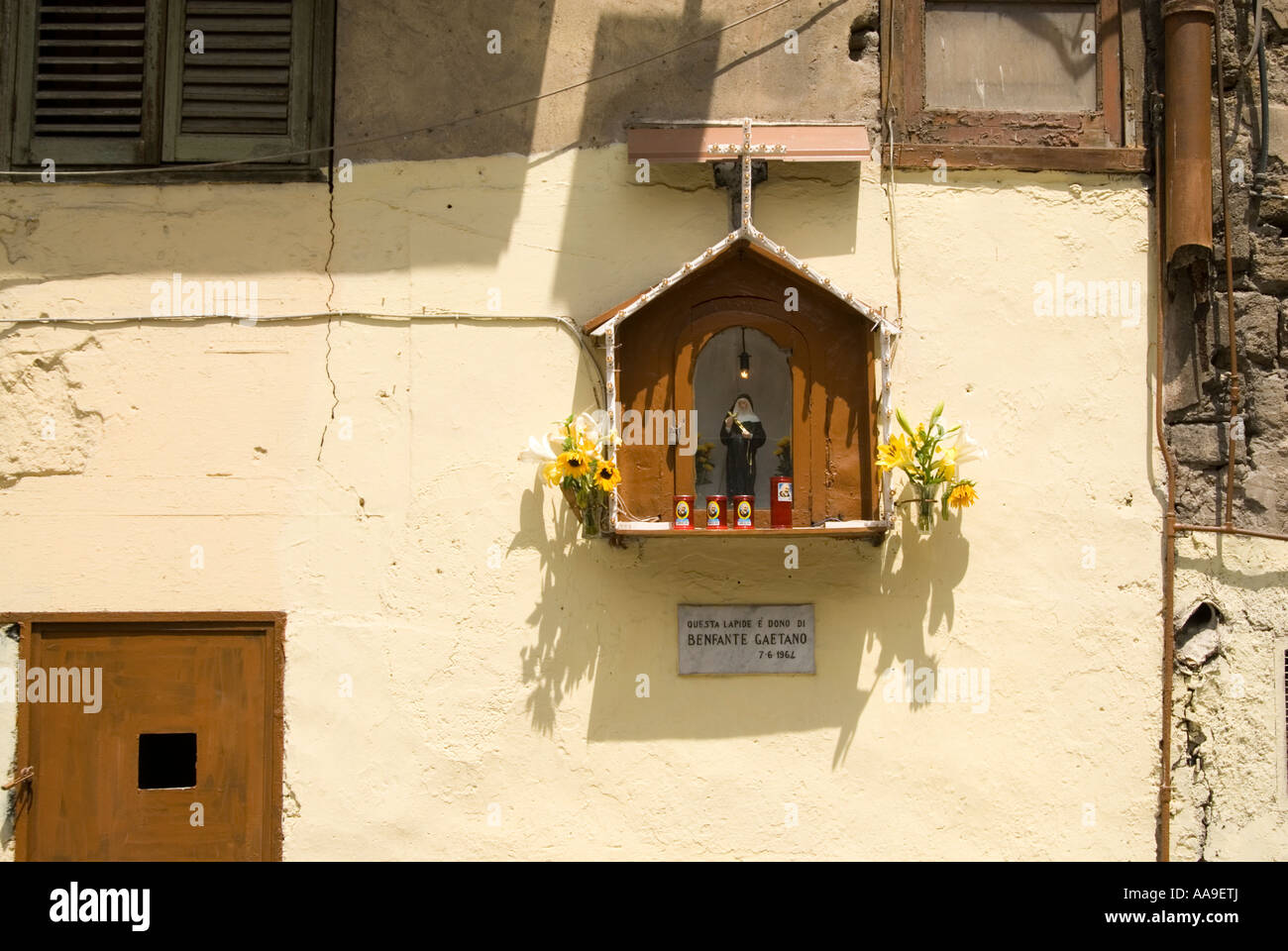 Small Christian religious shrine in the street on side of a house ...