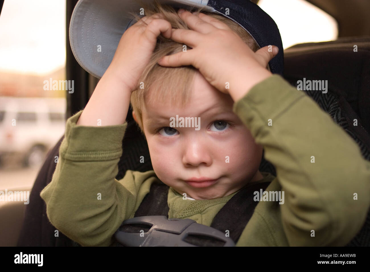 Little boy with hands on his head Stock Photo - Alamy