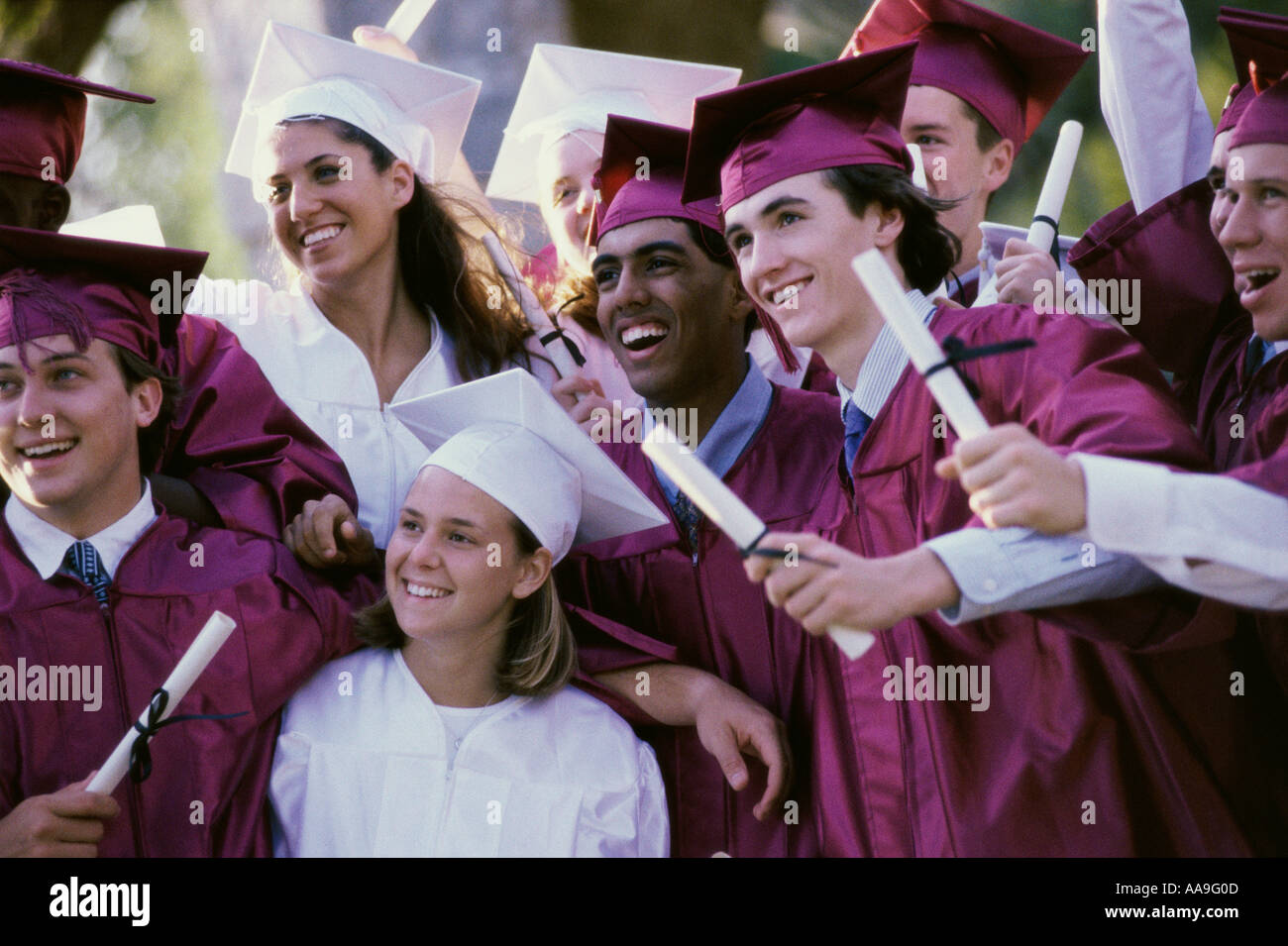 Group of teenagers holding their degrees on graduation day Stock Photo ...