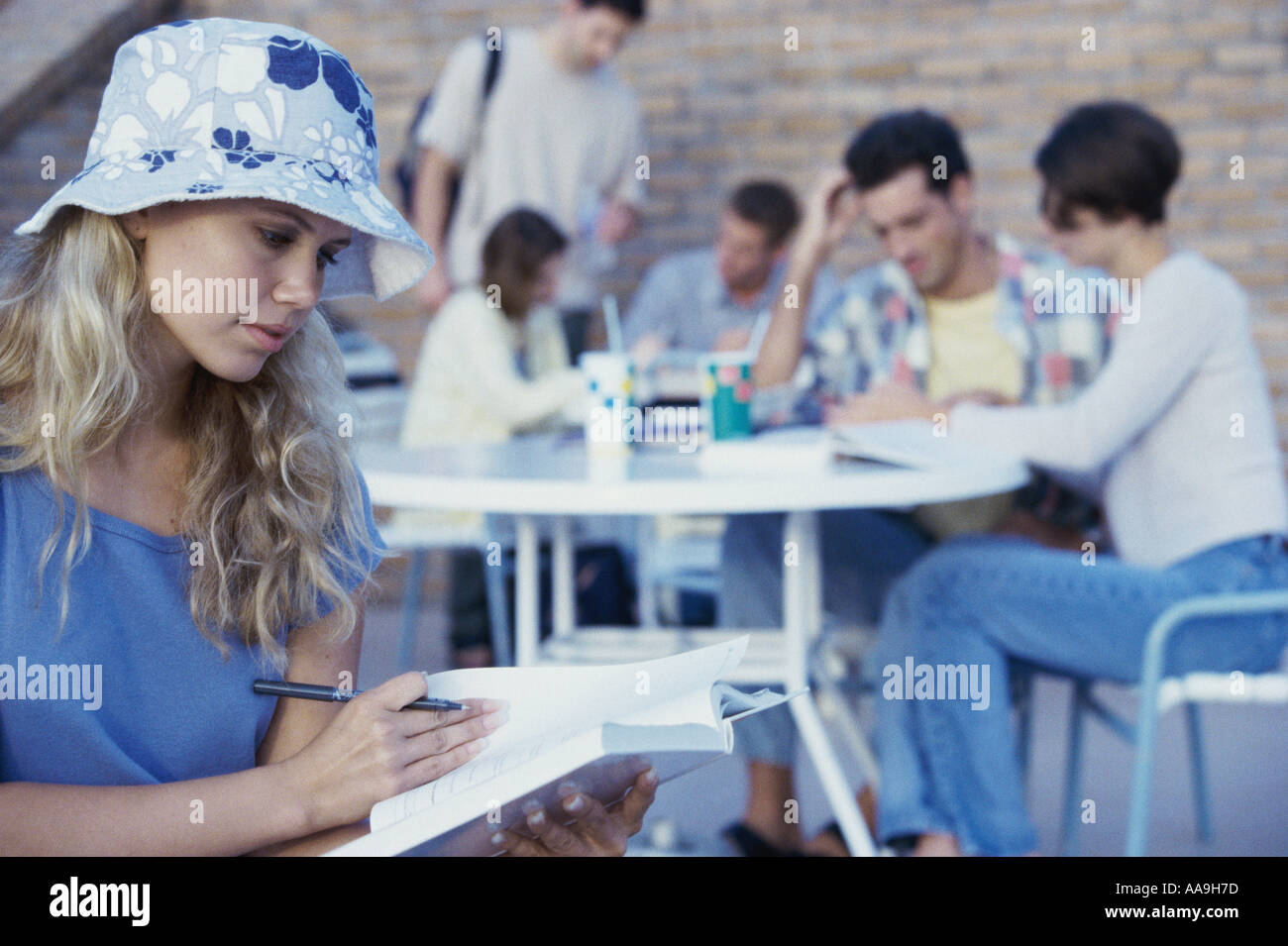 Teenagers seated at tables outdoors Stock Photo - Alamy