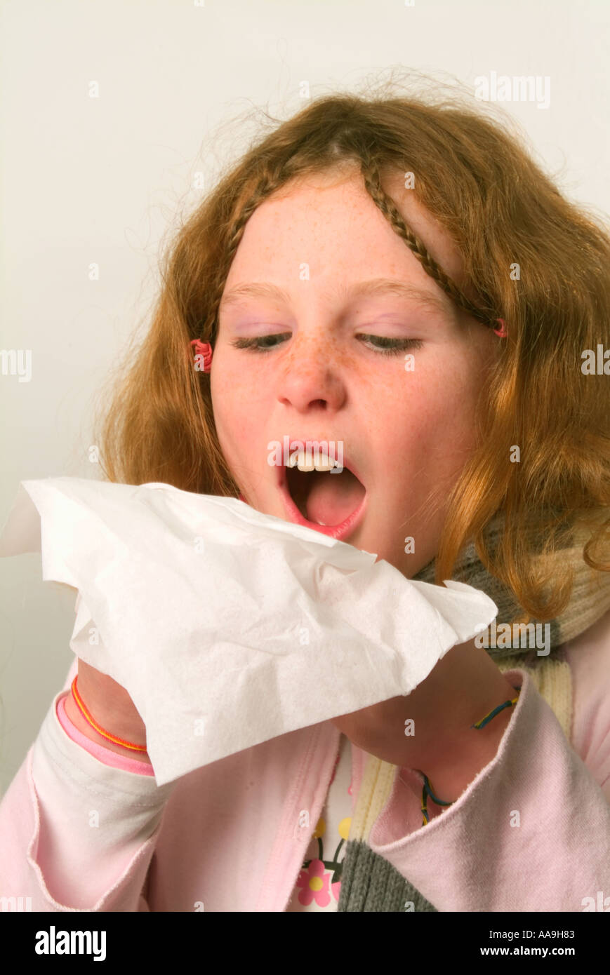 Young girl blowing her nose Stock Photo - Alamy