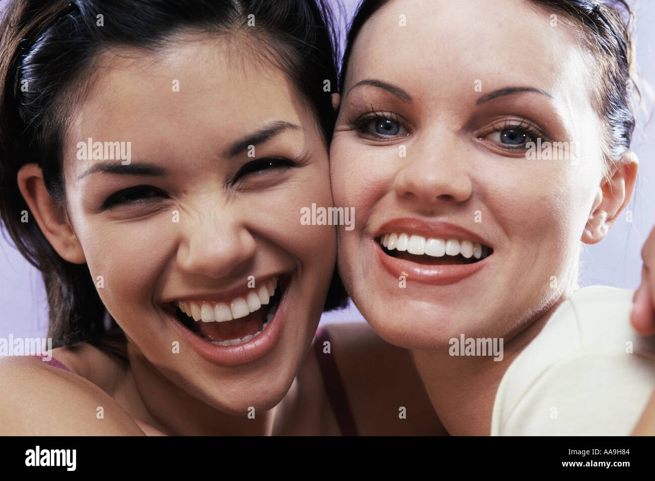 Portrait of two young women smiling Stock Photo - Alamy