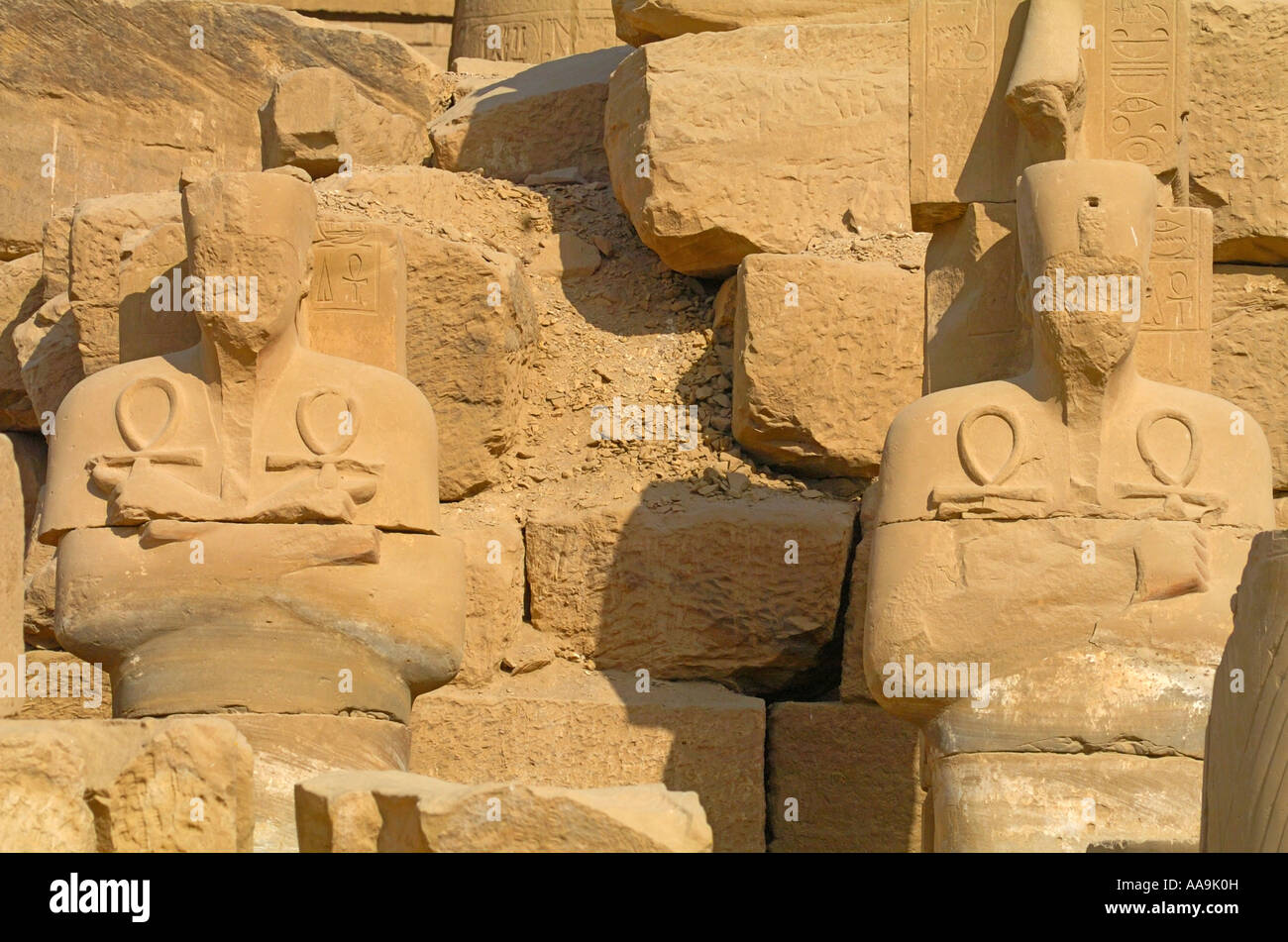 Stone statue holding the ankh in his hands at the Temple of Karnak ...