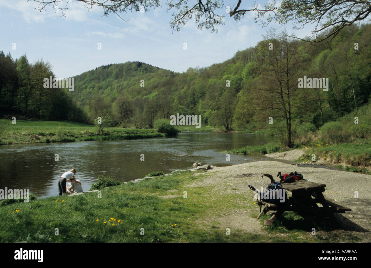 Walkers in the Belgian Ardennes resting by the the Semois river Belgium ...