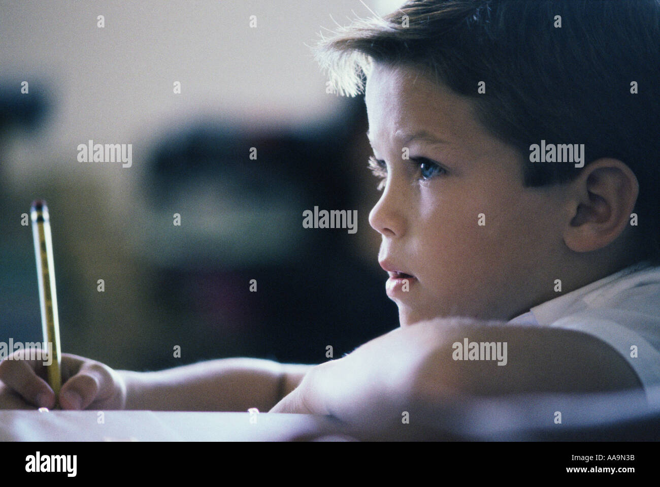 Side profile of a boy holding a pencil Stock Photo - Alamy