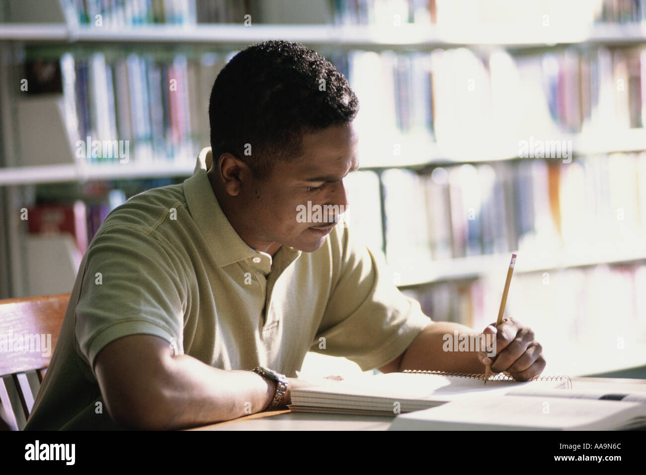 Side profile of a man writing in a notebook with a pencil Stock Photo ...