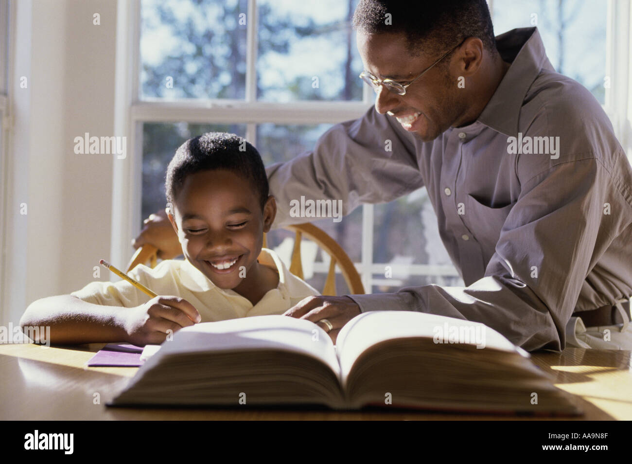 Father helping his son with homework Stock Photo - Alamy