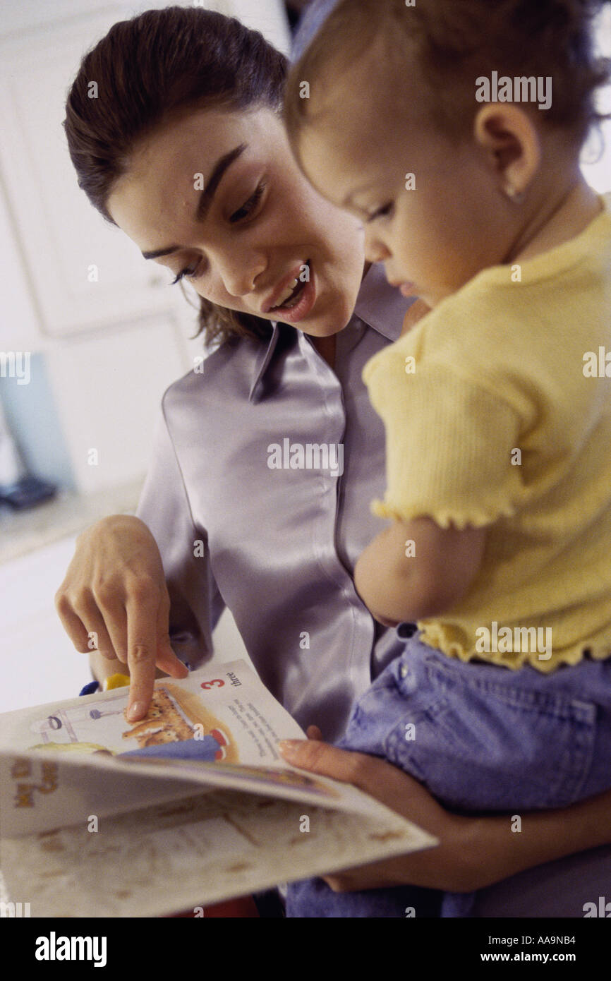 Mother and her child reading a book Stock Photo - Alamy