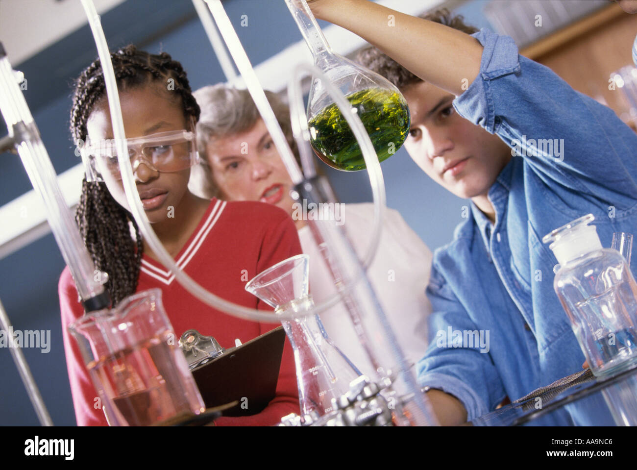Teenagers conducting an experiment in a chemistry laboratory Stock ...