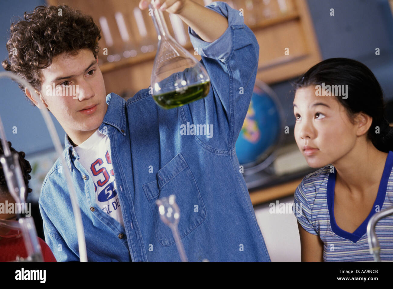 Teenagers conducting an experiment in a chemistry laboratory Stock ...