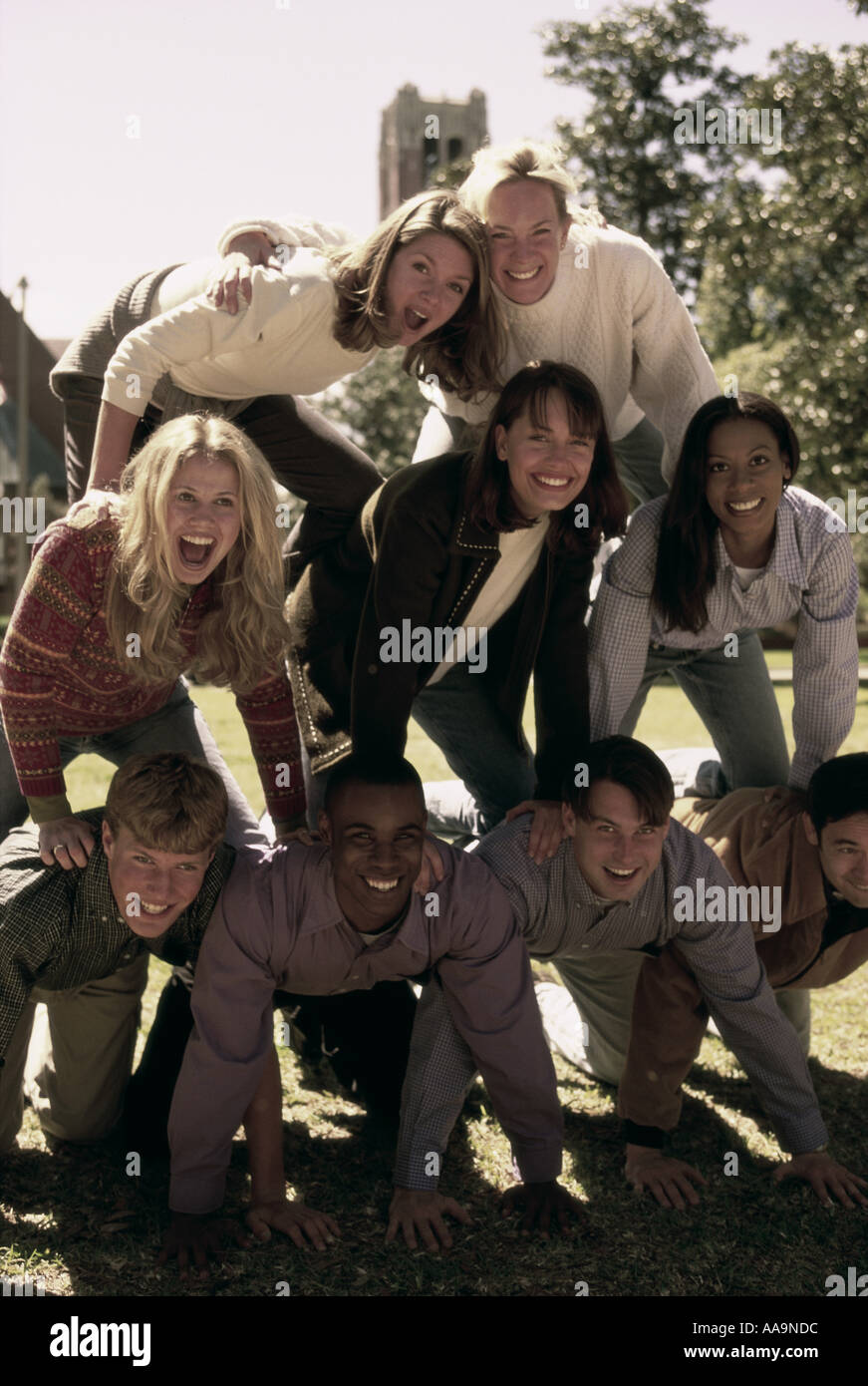 Portrait of a group of young people creating a pyramid Stock Photo - Alamy
