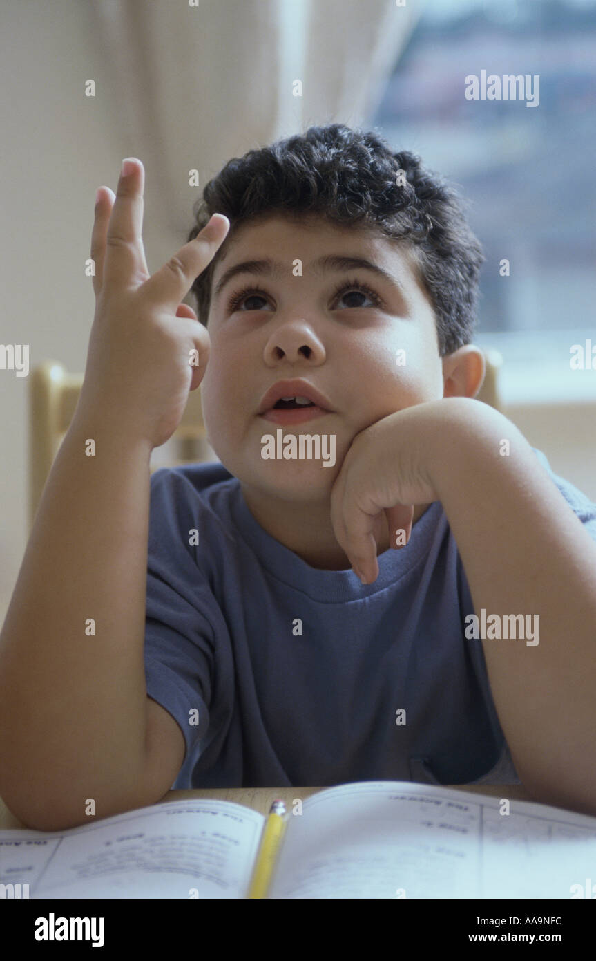 Boy counting on his fingers Stock Photo - Alamy
