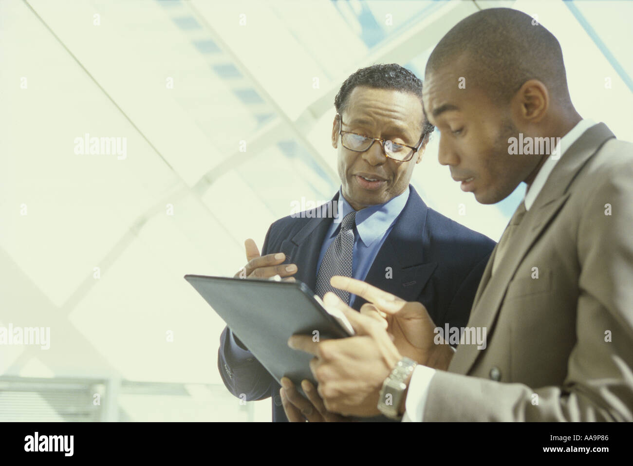 Two businessmen talking to each other Stock Photo - Alamy