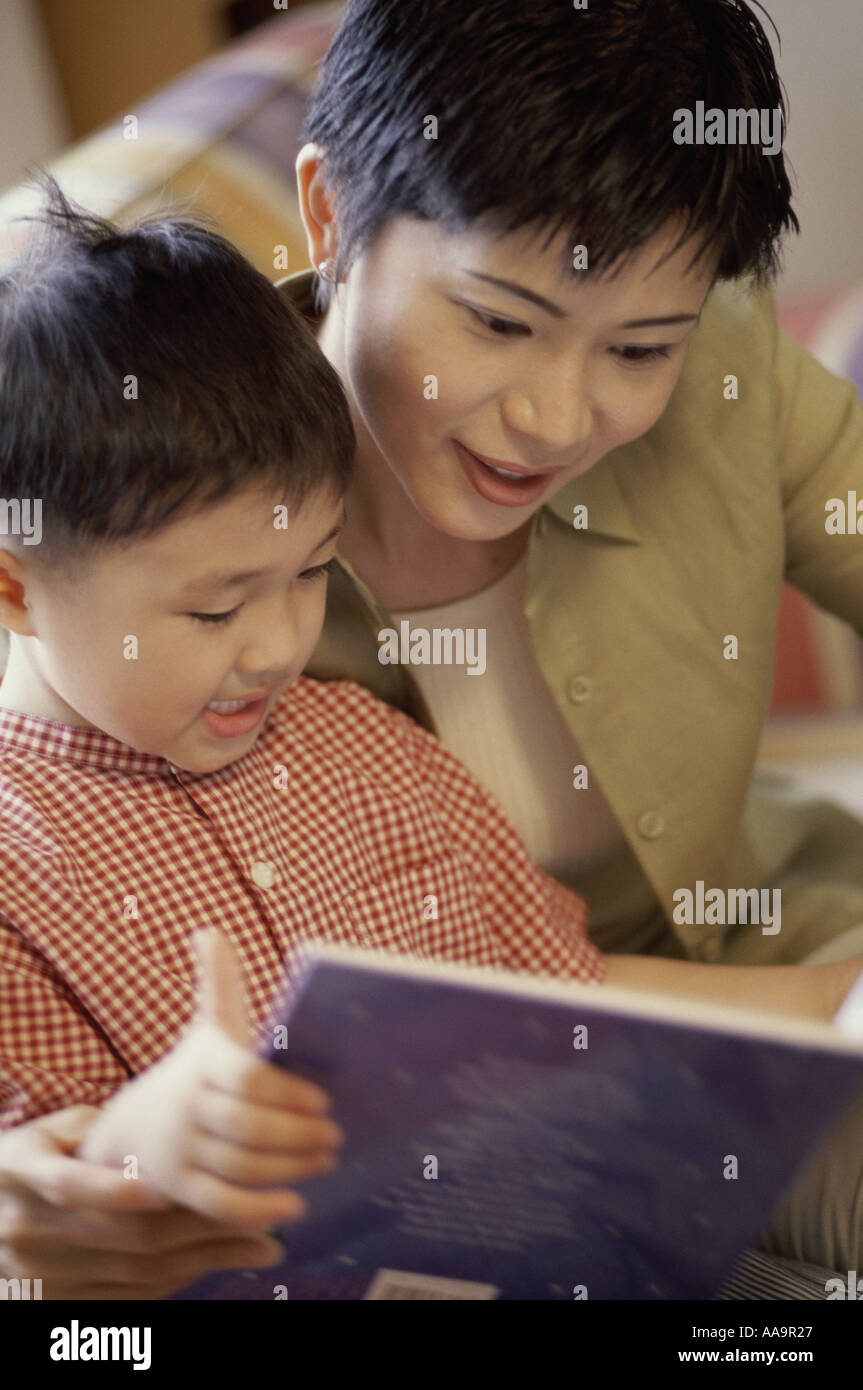 Mother and child reading a book Stock Photo - Alamy