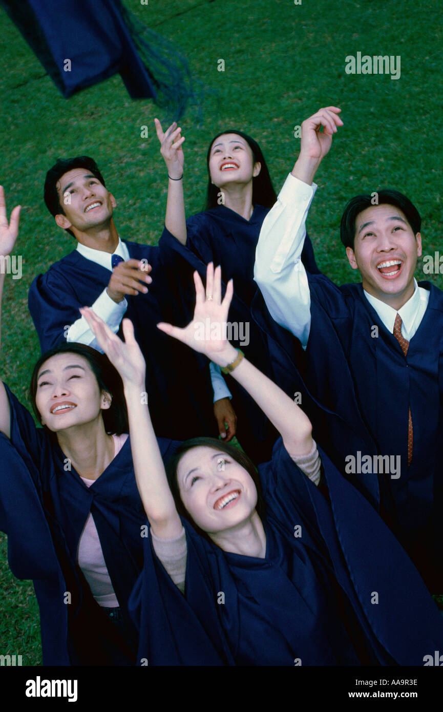 Group of students throwing their graduation hats in the air Stock Photo ...