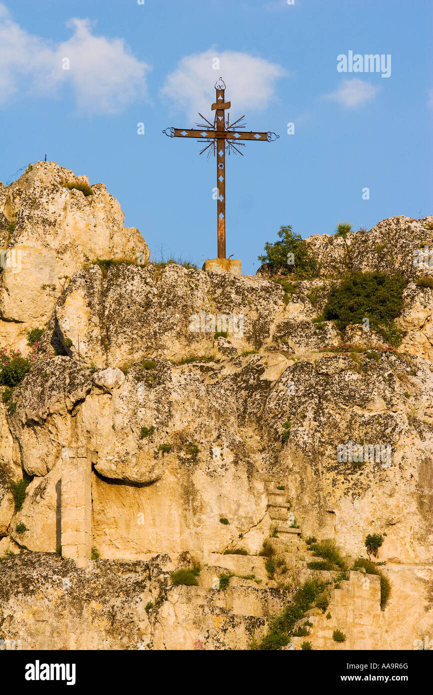 Stone steps carved in cliff above Sassi lead to rusty metal cross at ...