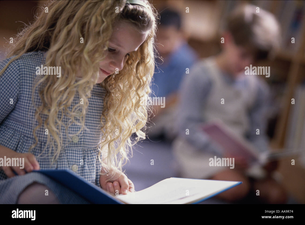 Girl reading a book Stock Photo - Alamy