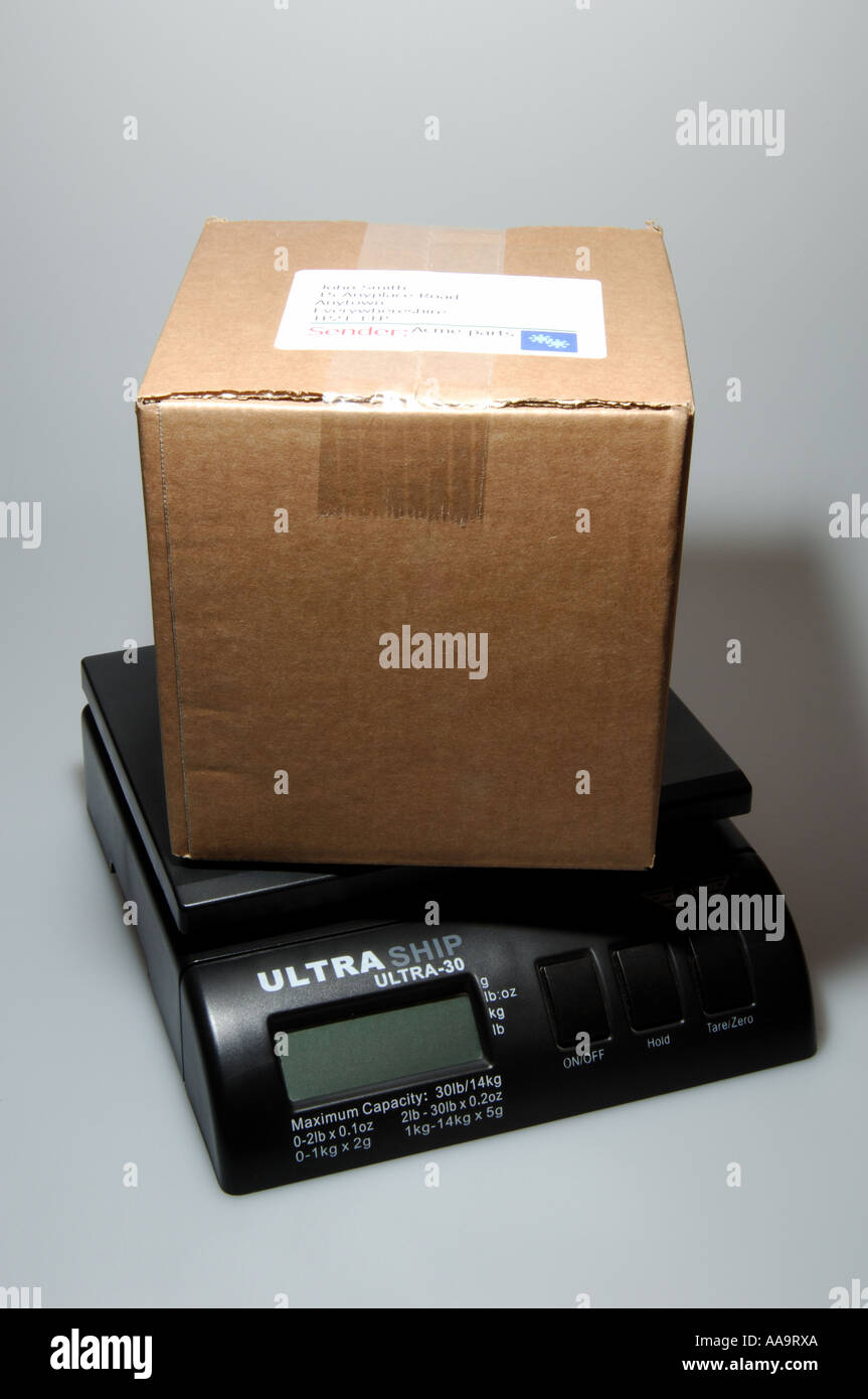 package on postage scales Stock Photo - Alamy