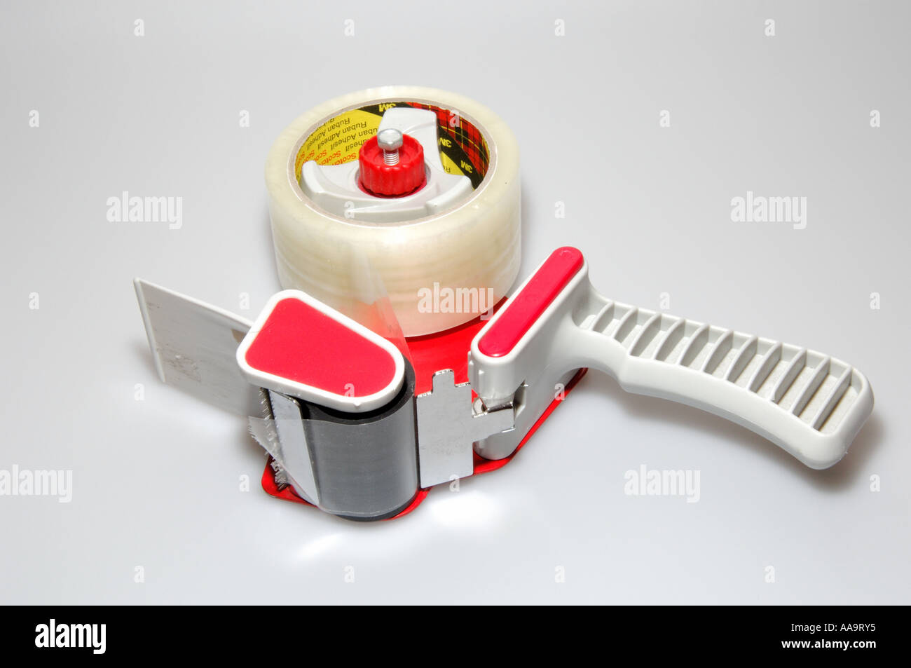 handheld sticky tape dispenser on white background Stock Photo - Alamy