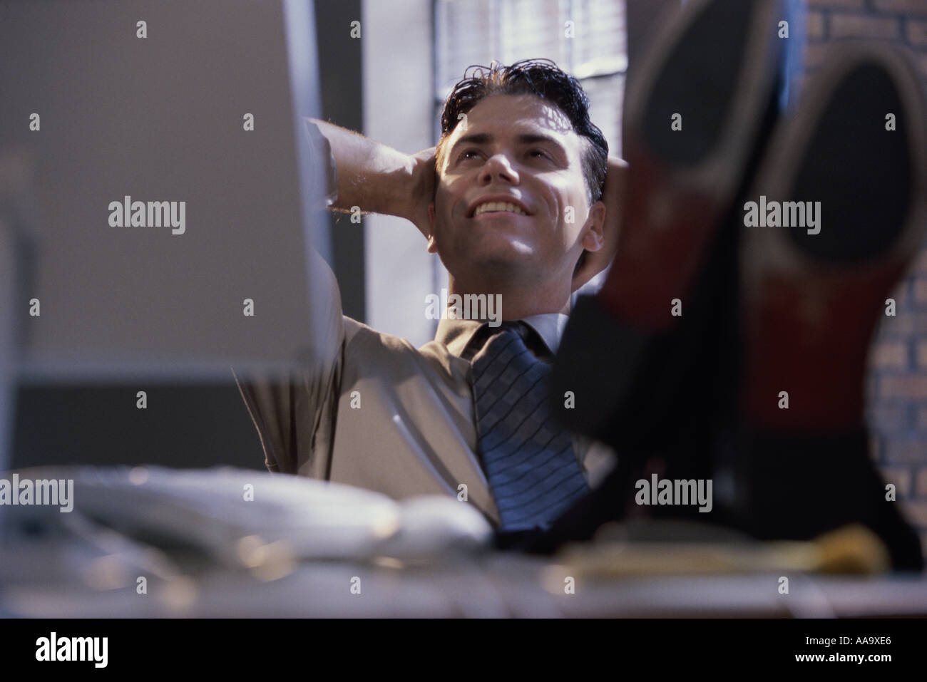 Feet on desk in front of man hi-res stock photography and images - Alamy