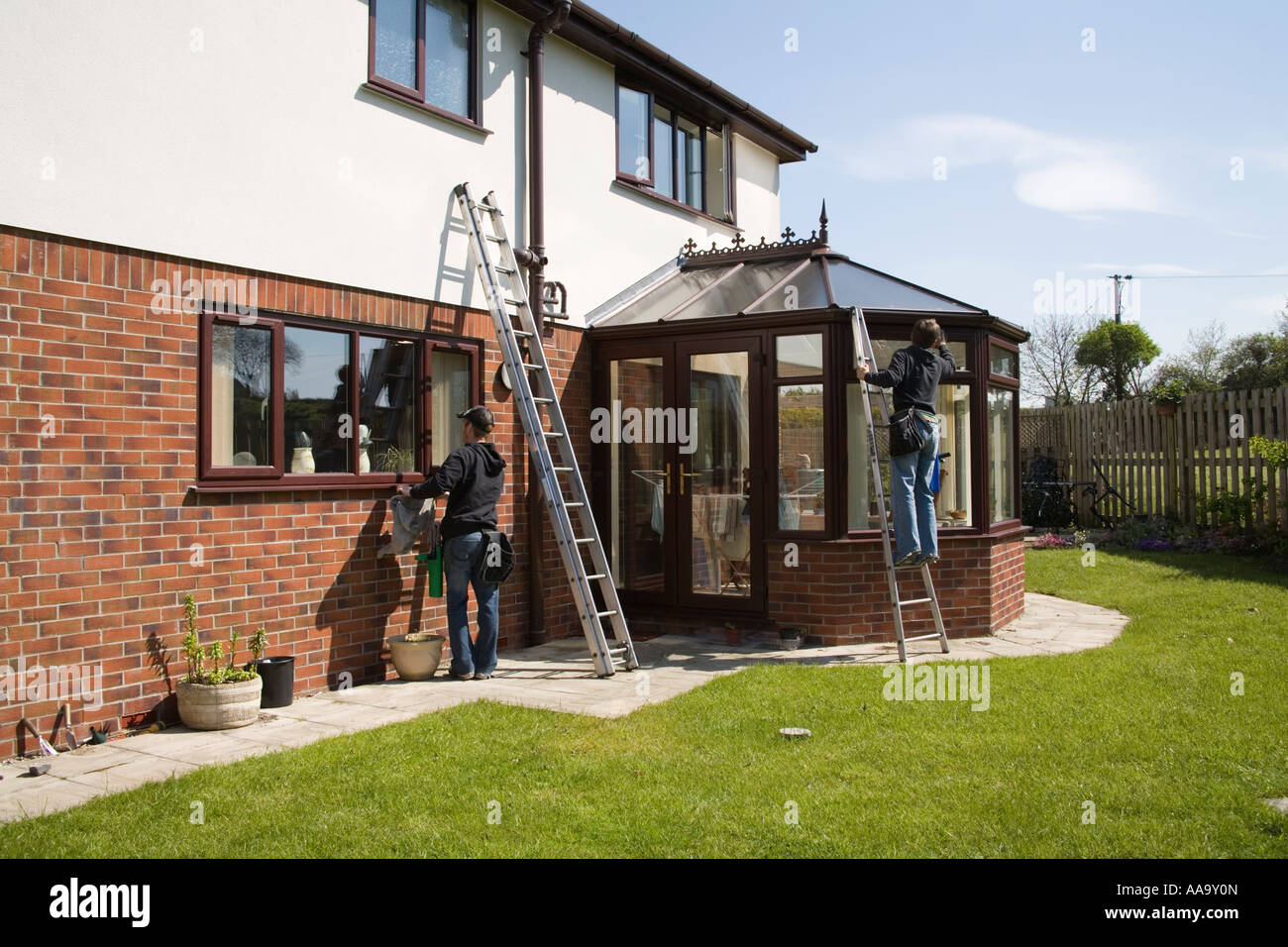 NORTH WALES April One young man up a ladder cleaning the windows of a ...