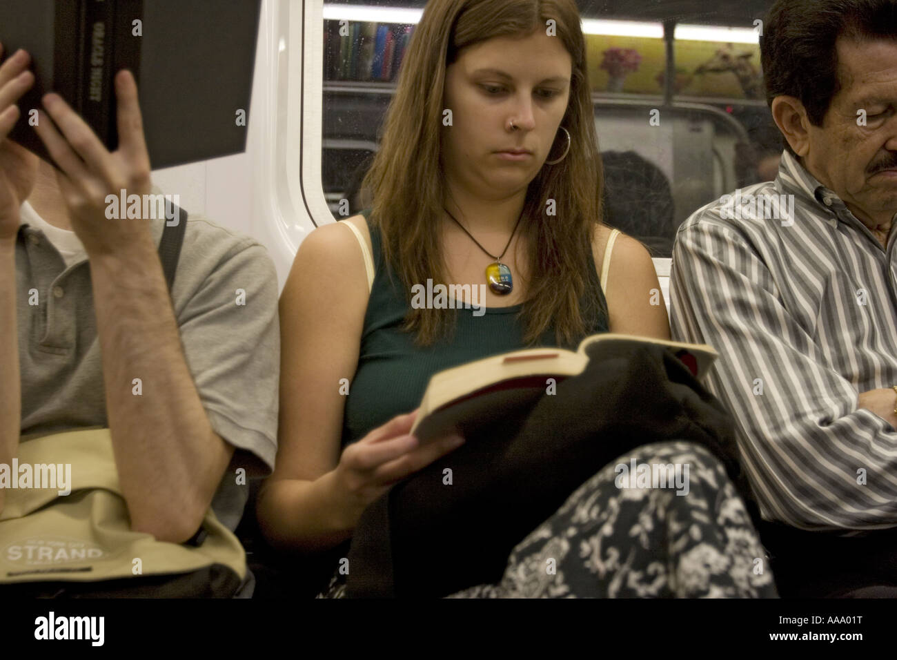 Lexington Avenue IRT NYC Passengers reading as they ride the subway in ...