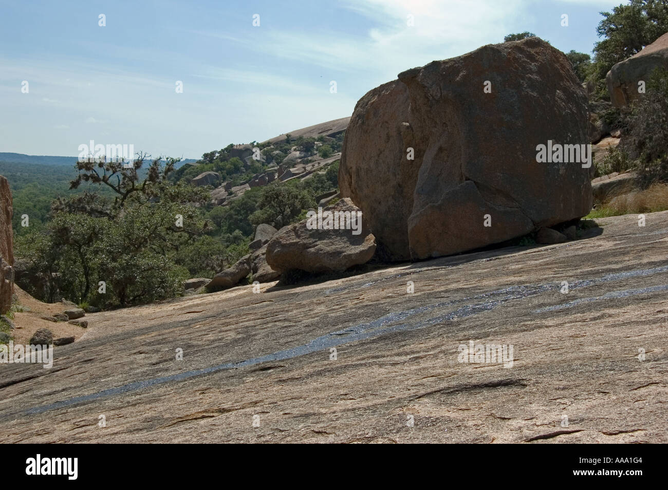 Boulder on granite mountain in rugged hill country Stock Photo - Alamy